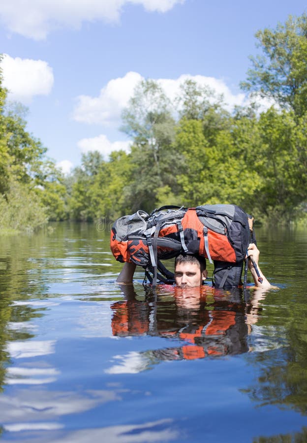 Man Crossing the River with a Backpack. Stock Photo - Image of danger ...