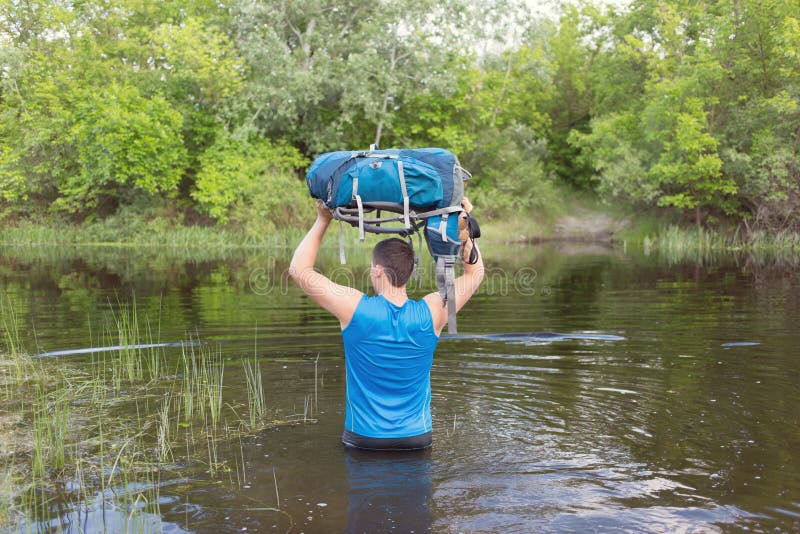 Man Crossing the River with a Backpack. Stock Photo - Image of walking ...