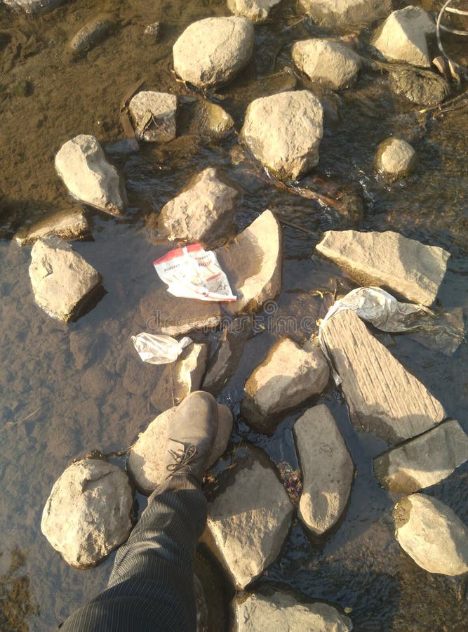 A Man Crossing a River by a Pool of Rocks Stock Photo - Image of asian ...