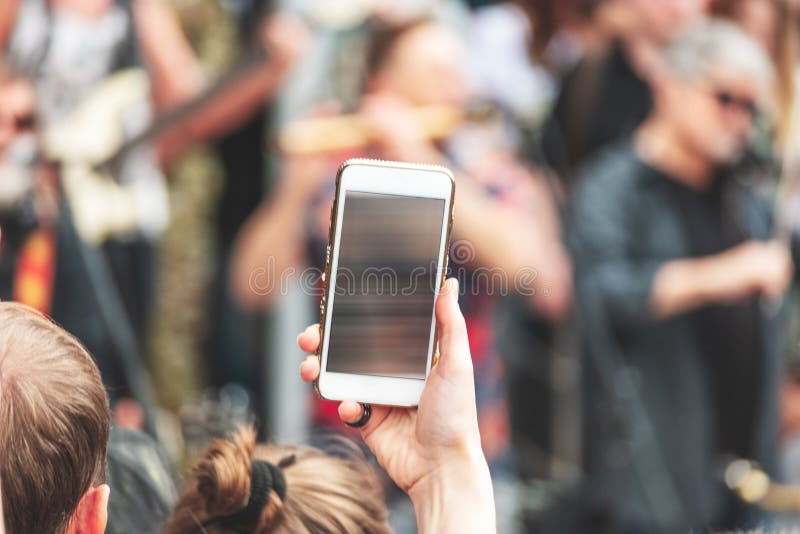 A Man from a Crowd Shoots a Street Performance on a Smartphone Stock ...