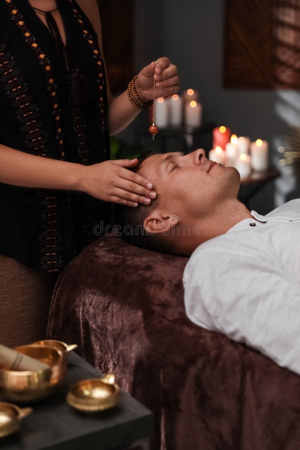 Man at Crystal Healing Session in Dark Room Stock Image - Image of ...