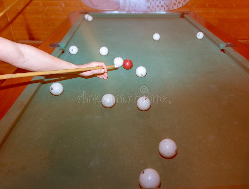 A Man with a Cue in His Hands Plays Billiards Stock Photo - Image of ...