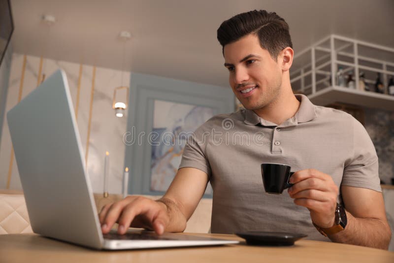 Man with Cup of Coffee Working on Laptop at Cafe Stock Image - Image of ...
