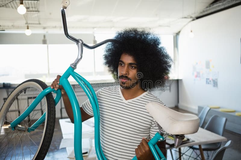 Man with Curly Hair Holding Bicycle at Office Stock Image - Image of ...