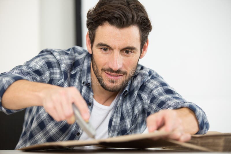 Man Cuts Cardboard for Books Stock Image - Image of creativity, blade ...
