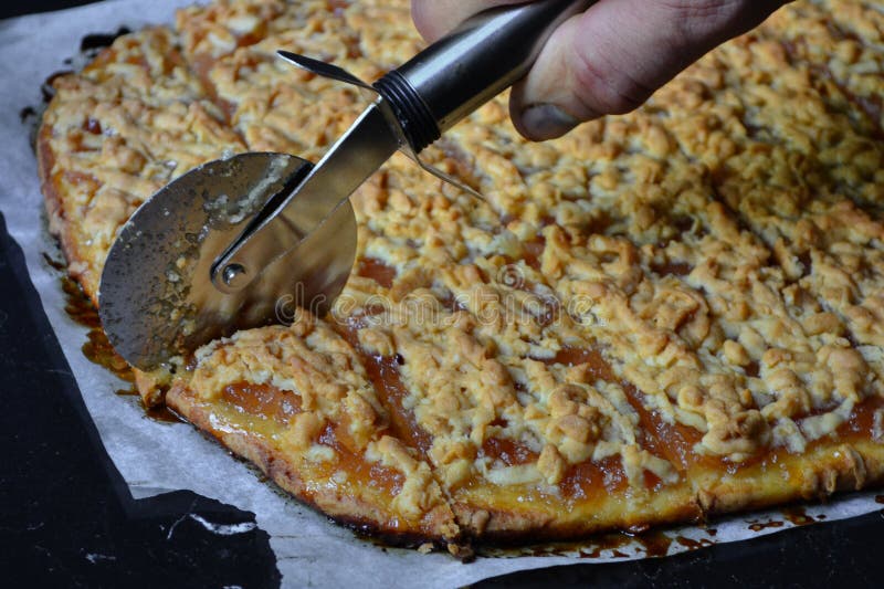 A Man Cuts a Grated Cake on the Table with a Knife Stock Image - Image ...