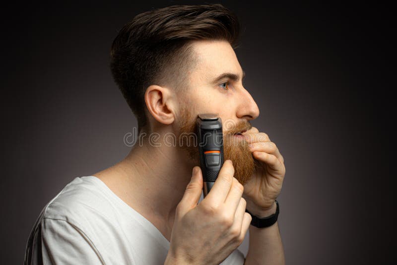 Man Cuts His Beard with a Trimmer Stock Photo - Image of care, bathroom ...
