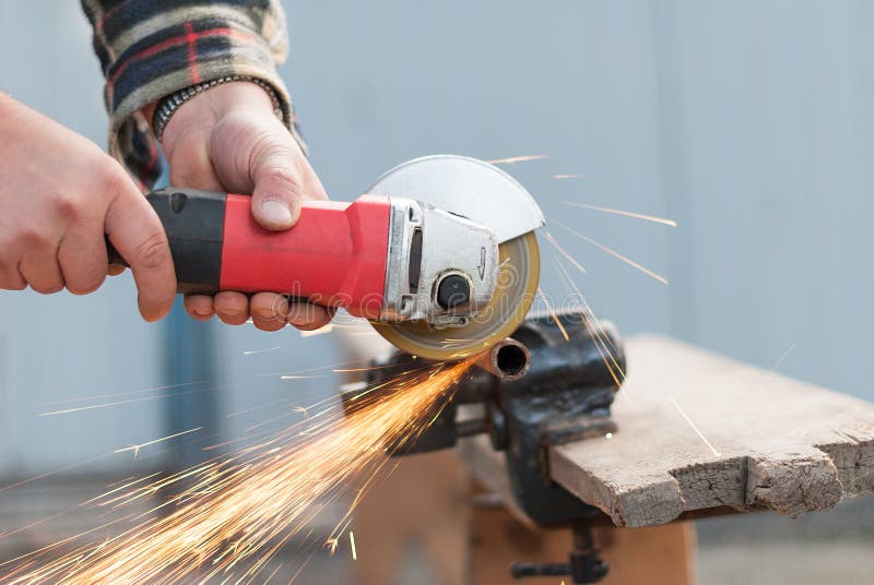 Man cuts a metal grinder. stock image. Image of cutting - 61146897