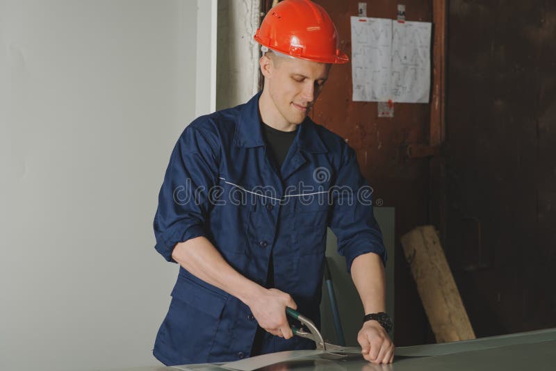 Man Cuts Metal Sheet with a Cutter Stock Image - Image of metal ...