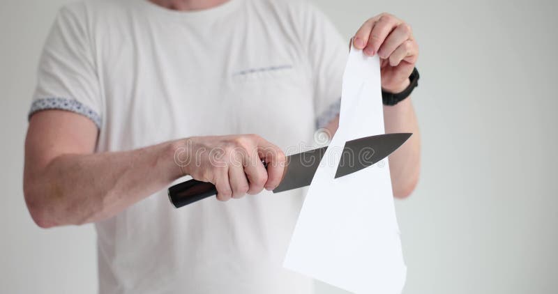 Man Cuts Paper Sheet with Sharp Knife in Light Studio Stock Footage ...
