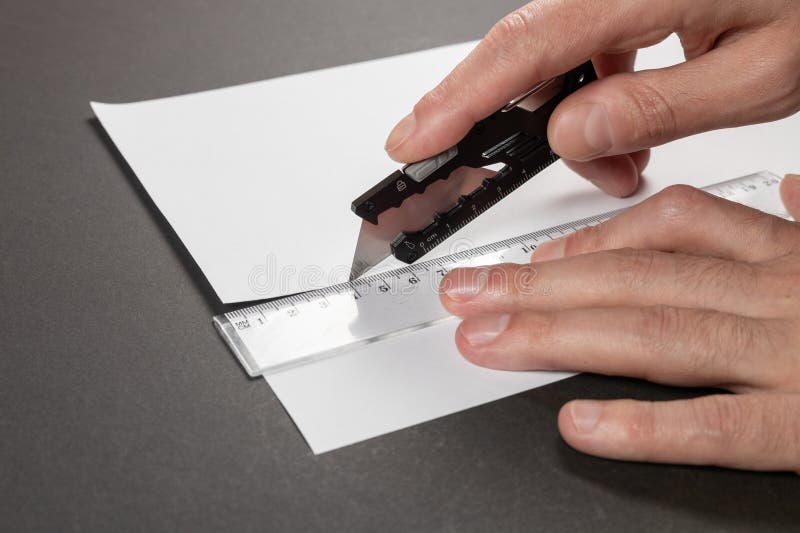 Man Cuts Paper with a Stationery Knife and Ruler Close Up Stock Image ...