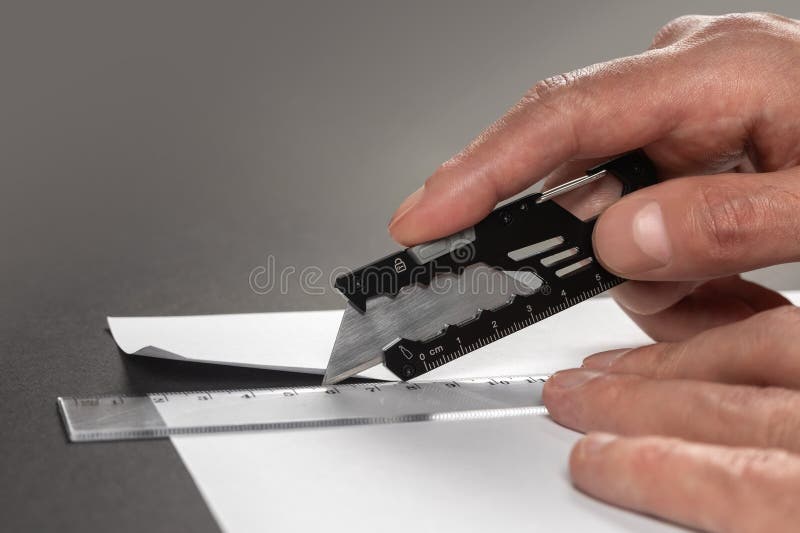 Man Cuts Paper with a Stationery Knife and Ruler Close Up Stock Image ...