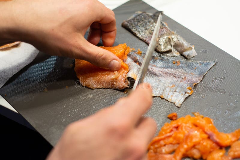 A Man Cuts Red Fish into Pieces. Stock Image - Image of food, carve ...