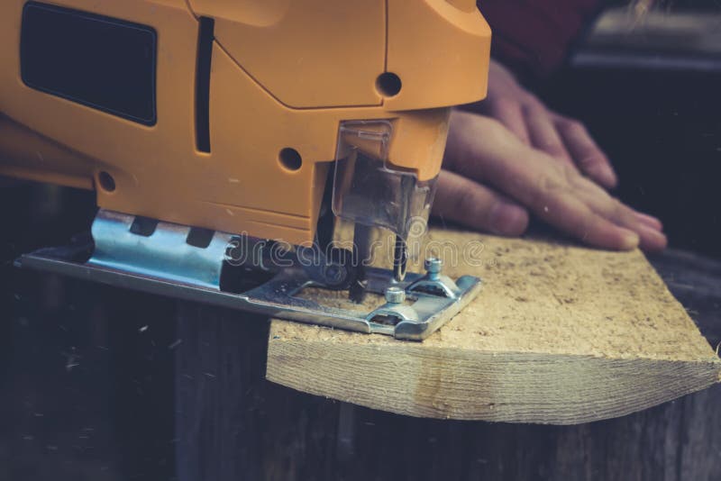 Man Cuts Wood Products, Using Electric Jigsaws Outdoors. Close-up Stock ...