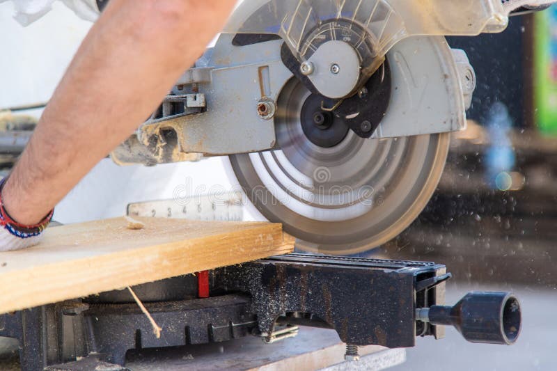 A Man Cuts Wood with a Sawmill. Selective Focus Stock Photo - Image of ...