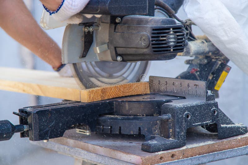 A Man Cuts Wood with a Sawmill. Selective Focus Stock Photo - Image of ...