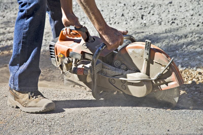 Man Cutting Asphalt stock photo. Image of construction - 16889710
