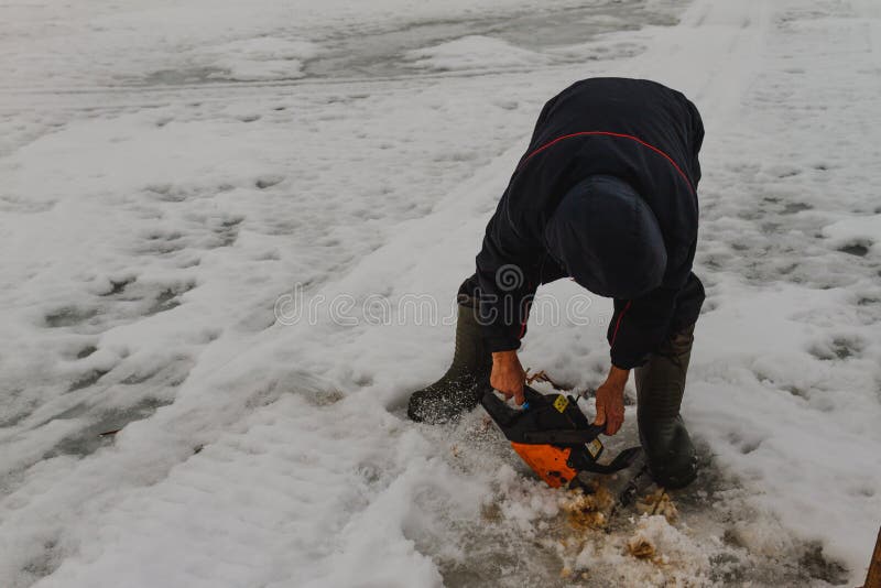 Man Cutting Chainsaw Shell in Ice Stock Image - Image of landscape ...