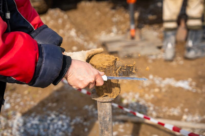 Man Cutting and Cleaning Soil Sample for Laboratory Analysis ...