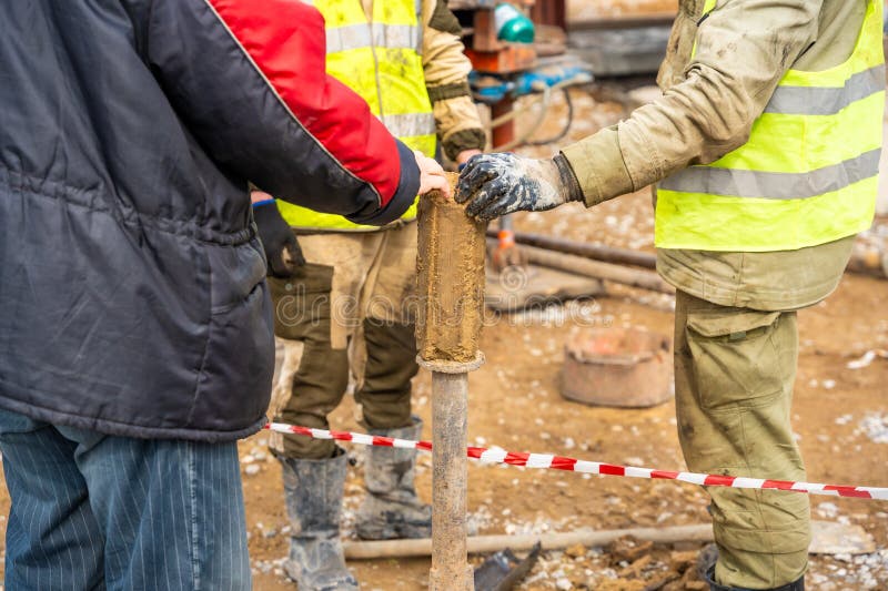 Man Cutting and Cleaning Soil Sample for Laboratory Analysis ...