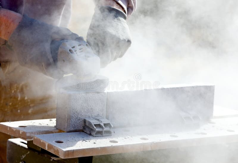 A Man Cutting Concrete Balk with a Lot of Dust in the Air Stock Image ...