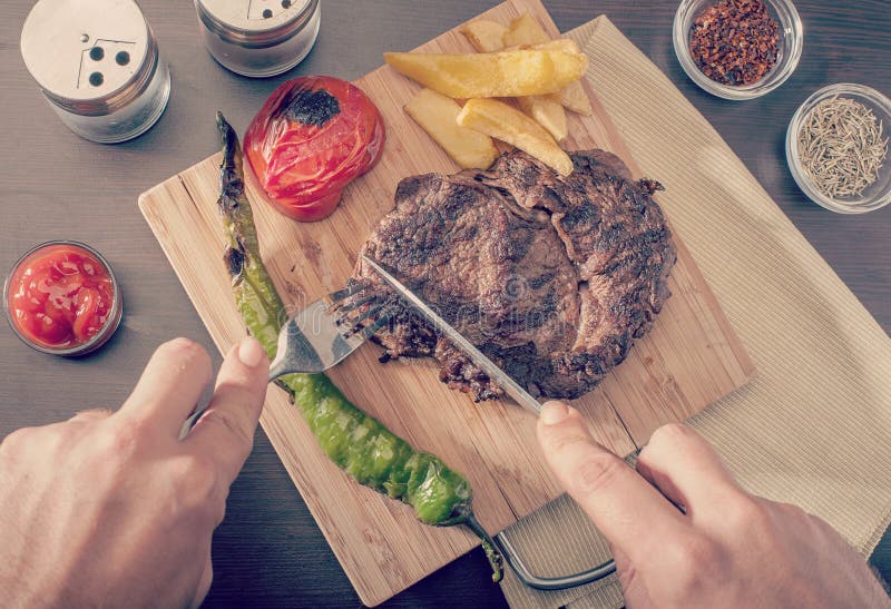 Man Cutting and Eating a Grilled Beef Steak Stock Image - Image of ...