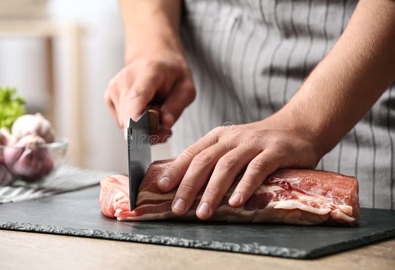 Man Cutting Fresh Raw Meat on Table in Kitchen Stock Image - Image of ...