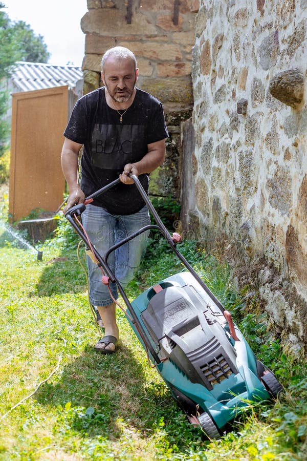 Man Cutting Grass in His Garden Stock Image - Image of mowing, person ...
