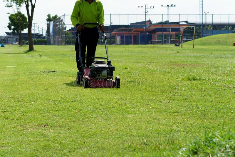 Man Cutting the Grass with Lawn Mower Stock Photo - Image of green ...