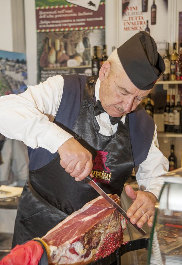 Man cutting a ham editorial photography. Image of prosciutto - 29566697