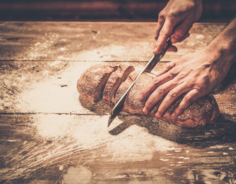 Man cutting homemade bread stock image. Image of making - 50887499