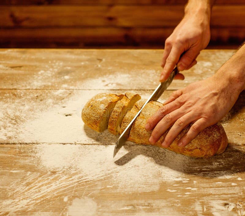 Man cutting homemade bread stock image. Image of gourmet - 51193243