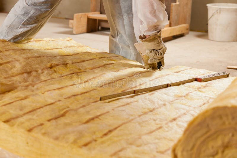 Man Cutting Insulation Material for Building Stock Image - Image of ...
