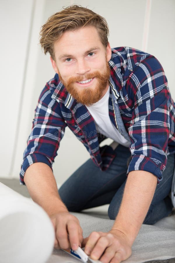 Man cutting linoleum floor stock photo. Image of trim - 265786554