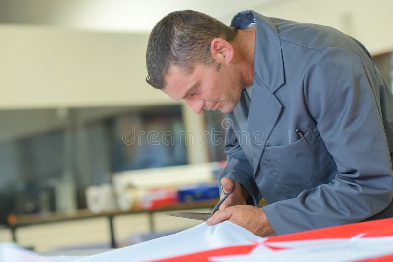 Man cutting material stock photo. Image of waterproof - 245861852