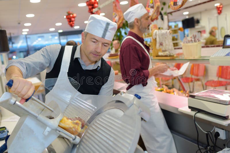 Man Cutting Meat with Industrial Machine Stock Photo - Image of dried ...