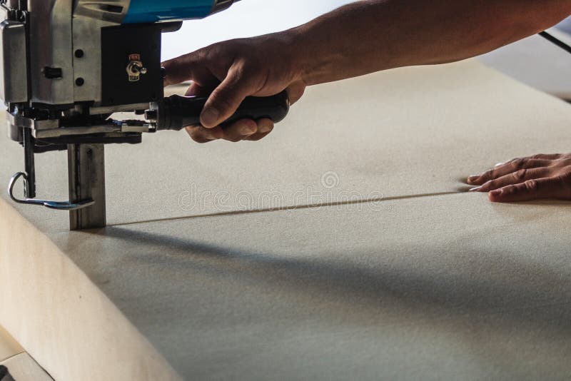 Man cutting foam rubber stock image. Image of decoration - 204975243
