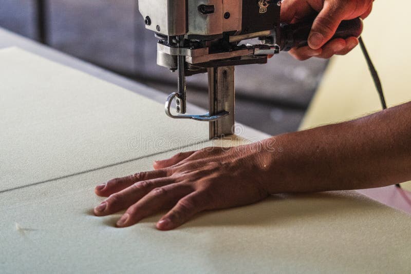 Man cutting foam rubber stock image. Image of england - 204975253