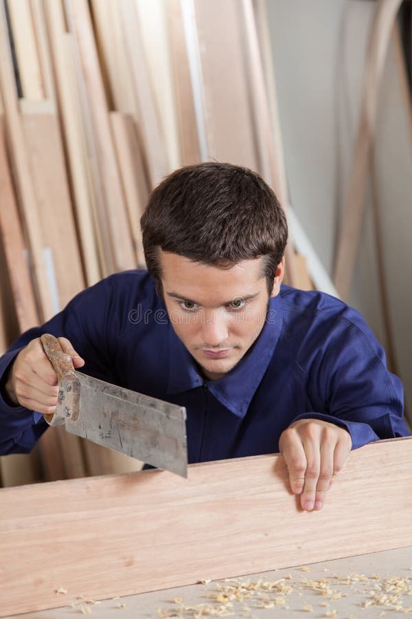 Man cutting a plank stock photo. Image of model, carpenter - 65257566