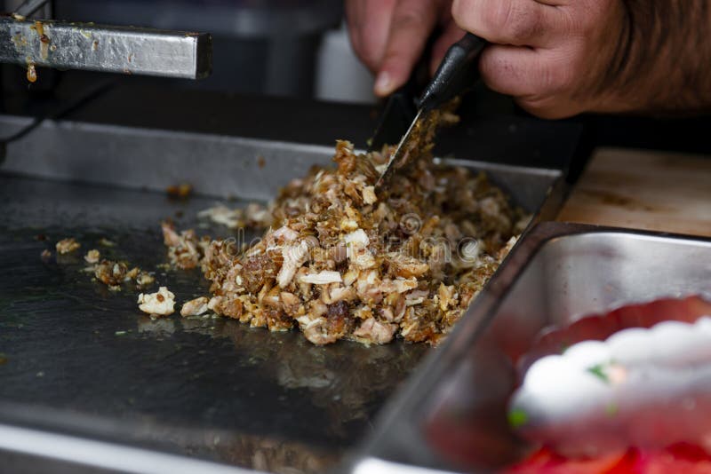 Man cutting prepared meat stock image. Image of gyros - 266400791