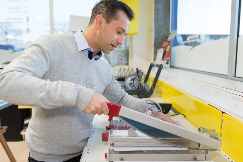Man Cutting Print with Precision Machine Stock Image - Image of laying ...