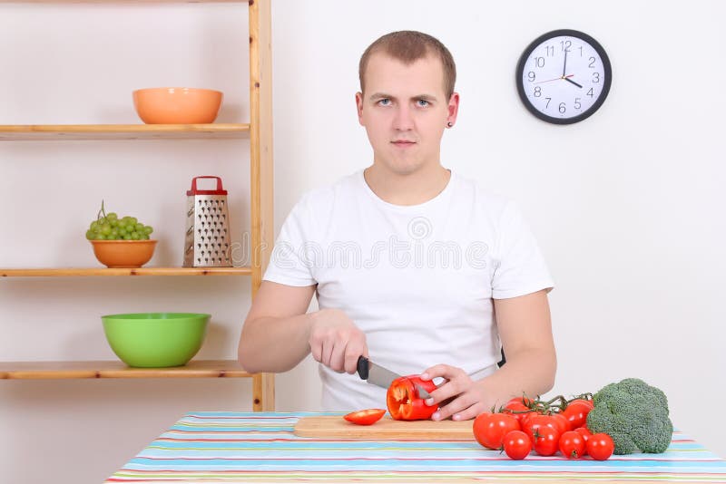 Man Cutting Red Pepper in the Kitchen Stock Photo - Image of clock ...