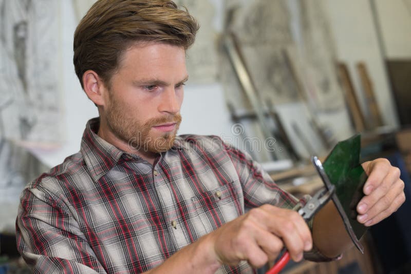 Man Cutting Something with Metal Tool Stock Image - Image of object ...