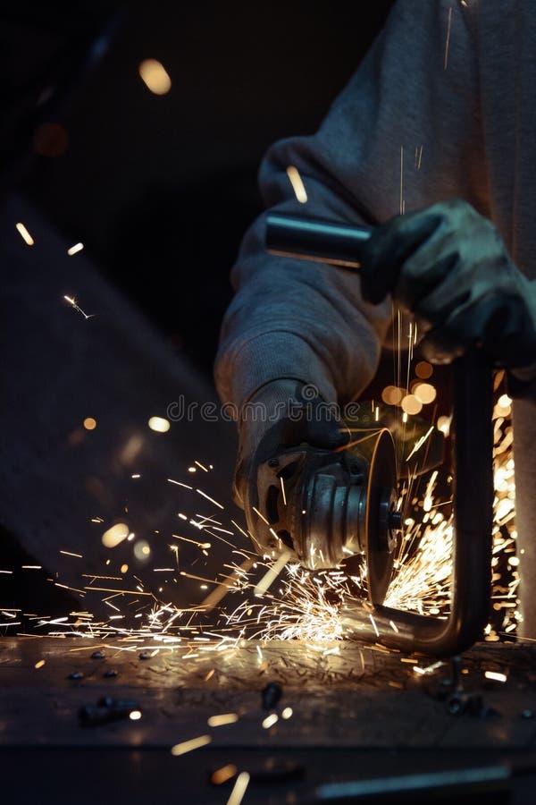 Man Cutting Steel Pipe with Many Sharp Sparks on a Metal Surface. Stock ...