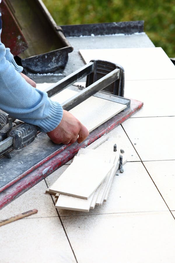 Man cutting tile by cutter stock image. Image of ceramic - 40029911