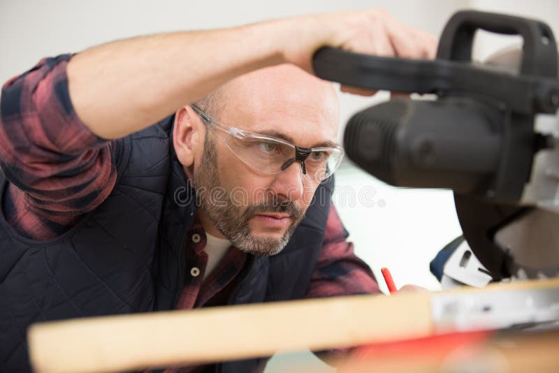 Man cutting wood stock photo. Image of 50years, occupation - 226432698