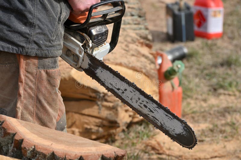 Man Cutting Wood with Chainsaw Stock Photo - Image of lumberjack, brown ...