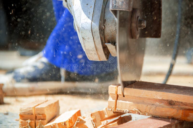 Man cutting wood with saw stock image. Image of power - 70696355