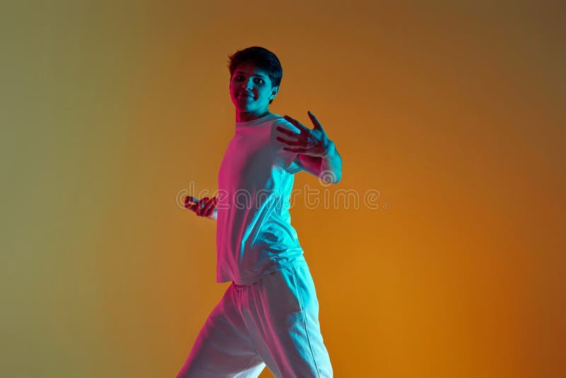 Man Dancing on Yellow Background. Neon Lighting Stock Photo - Image of ...