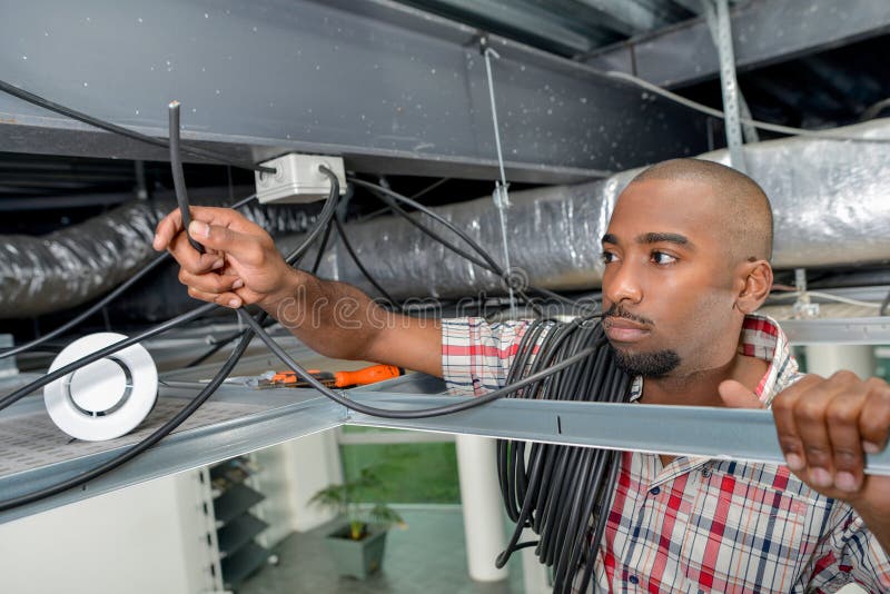 Man Dealing with Loose Cable Stock Photo - Image of electricity ...